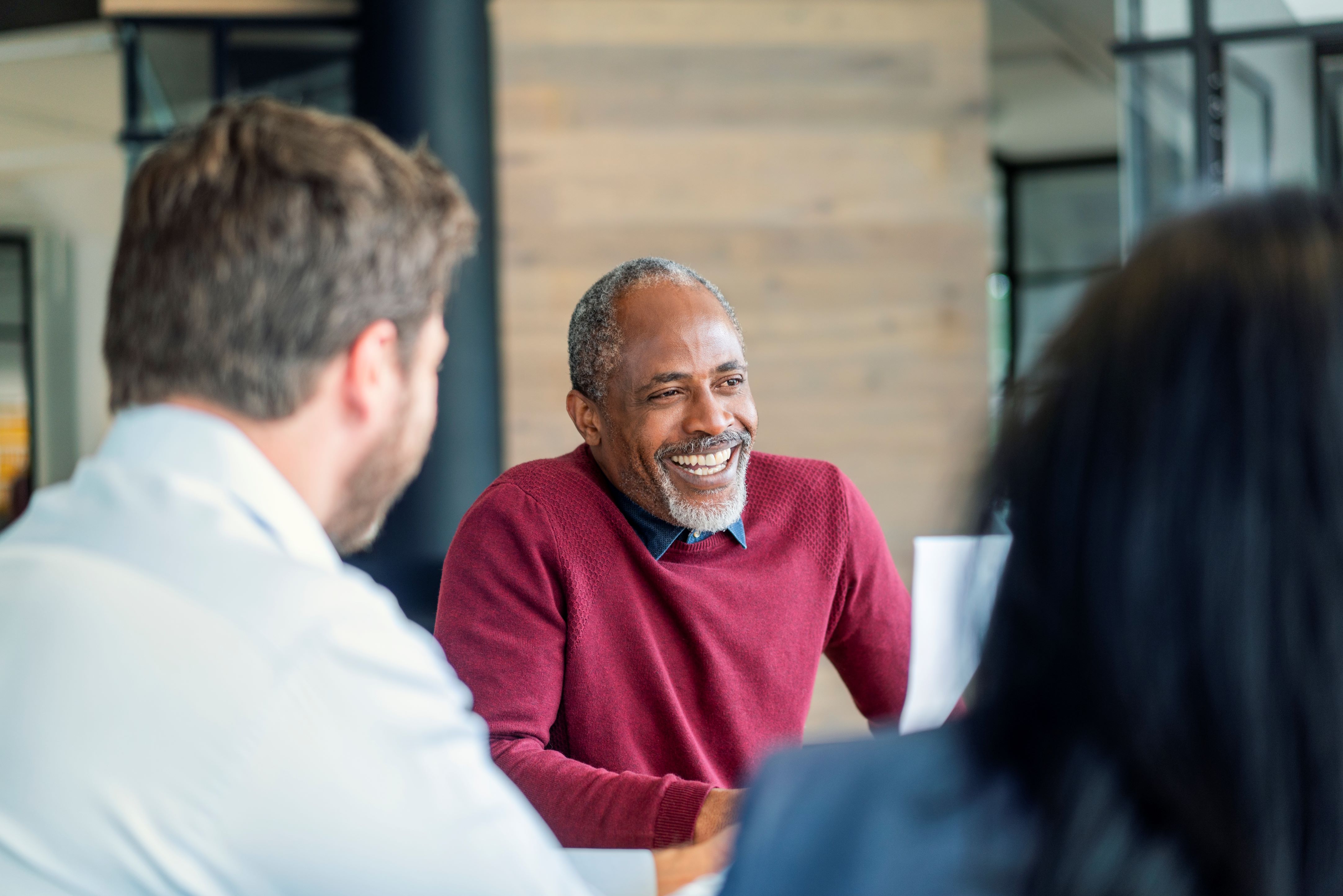 Background image with a smiling casual meeting